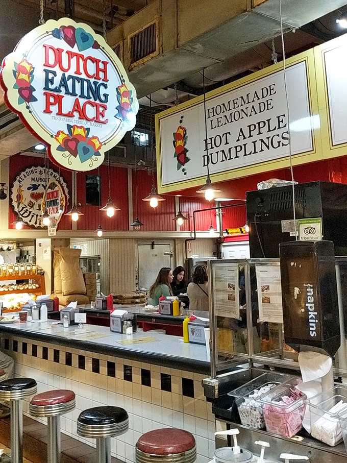 The iconic Dutch Eating Place sign promises culinary treasures within Reading Terminal Market. Those colorful hearts aren't just decoration&mdash;they're a preview of the heartfelt cooking awaiting you.