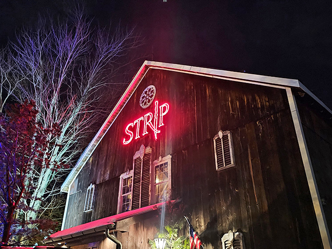 A rustic barn reborn as a culinary destination. Strip Steakhouse's weathered exterior and bright wooden doors promise delicious secrets within.