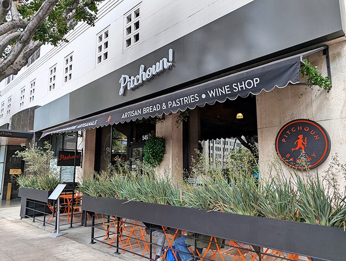 The sleek black awning of Pitchoun! promises Parisian delights in downtown LA. Orange chairs beckon you to linger over coffee and watch the world go by.