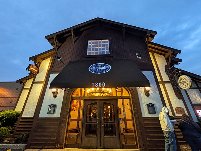 The Bavarian Lodge stands like a storybook cottage against the twilight sky, beckoning hungry travelers with its warm glow and Alpine charm.