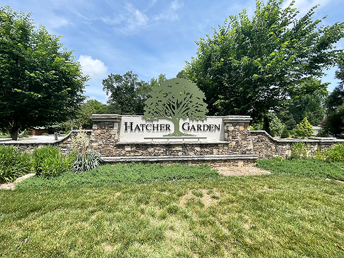 The stone entrance sign to Hatcher Garden stands like nature's business card – elegant, understated, and promising adventures beyond the ordinary.