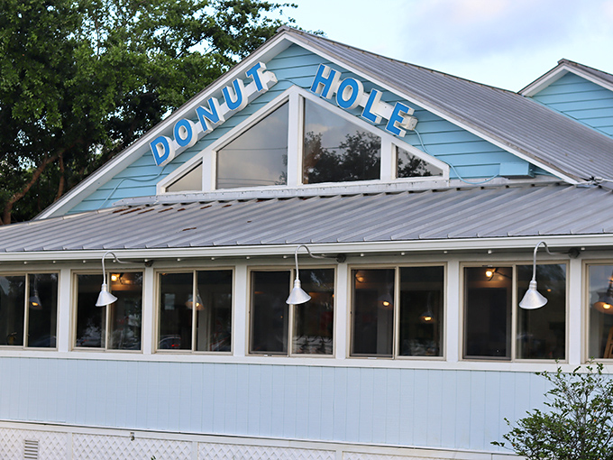 The iconic blue exterior of Donut Hole announces itself like a breakfast lighthouse guiding hungry travelers to safe harbor in Destin's sea of dining options.