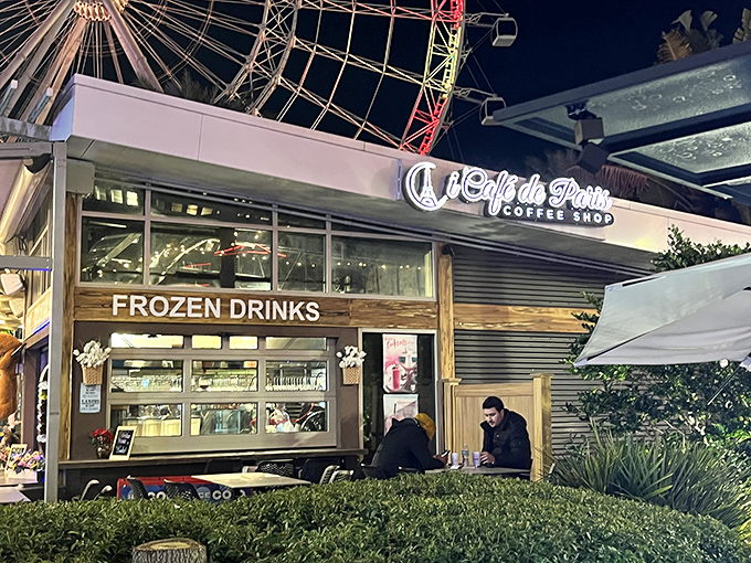 iCafe de Paris glows like a beacon next to Orlando's observation wheel, promising European charm with a side of Florida flair.