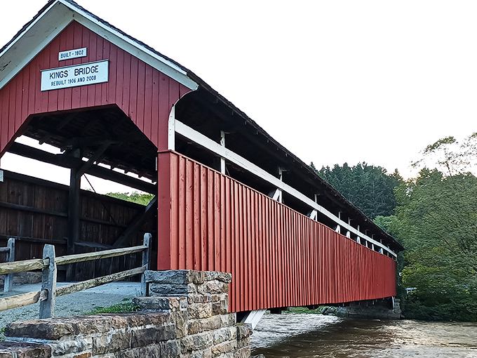 The classic red exterior of King's Bridge stands in stark contrast to the lush Pennsylvania greenery, like a crimson bookmark in nature's novel.