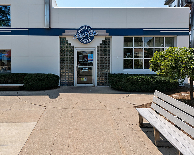 The blue neon sign beckons like a lighthouse for hungry souls. This converted gas station now fuels Madison residents with comfort food rather than automobiles.