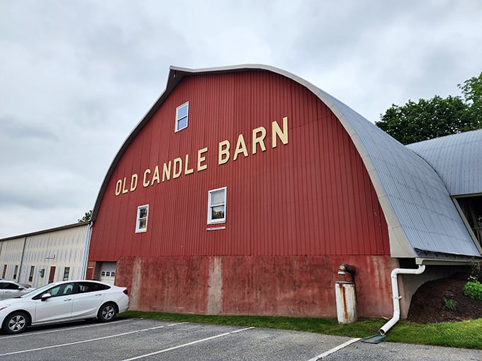 The iconic red barn exterior stands as a beacon of charm in Amish Country, promising treasures within its curved roof.