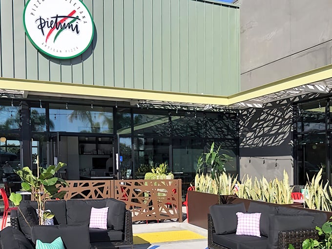 The unassuming exterior of Pietrini Pizza Napoletana proves once again that California's best culinary treasures often hide in plain sight, surrounded by pampas grass and promise.