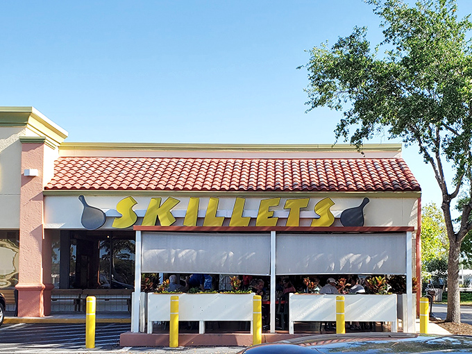 The sunshine-yellow Skillets sign promises breakfast paradise, standing out against Florida's blue sky like a beacon for hungry morning wanderers.