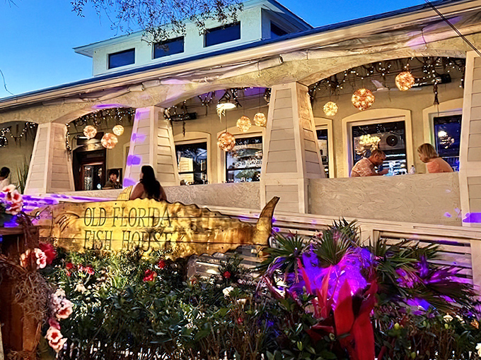 The turquoise-trimmed entrance beckons like a siren song, promising seafood treasures under the shade of Florida oaks. A beach vacation for your taste buds awaits.