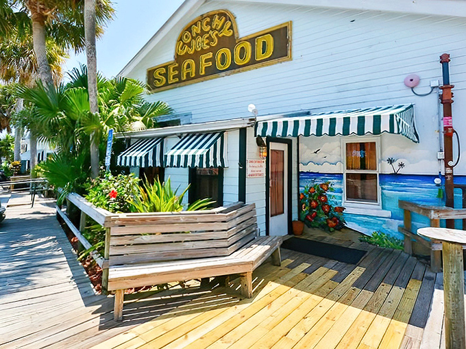 The pale blue exterior of Conchy Joe's stands like a tropical mirage against Florida's sky, promising seafood treasures within those weathered walls.