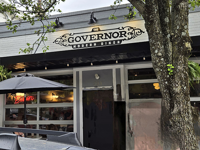 The Governor's inviting exterior beckons with lush hanging ferns and modern metal seating. Small-town charm meets contemporary dining at its finest.