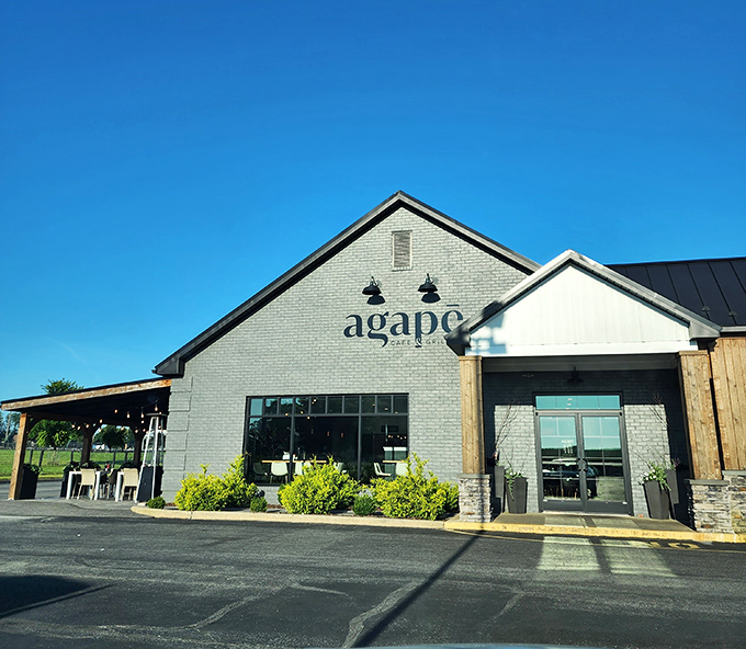The modern farmhouse exterior of Agapē beckons with its sleek gray facade and inviting patio. Those string lights aren't just decoration&mdash;they're a promise of good things to come.