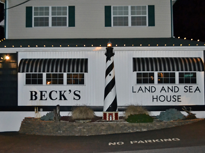 Beck's iconic lighthouse facade welcomes hungry travelers like a culinary beacon in the night, promising seafood treasures within.