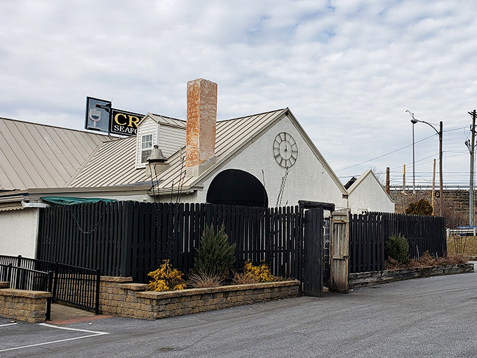 Twilight transforms Creed's into a glowing beacon of culinary promise, its distinctive clock face and twinkling lights beckoning hungry travelers like a gastronomic lighthouse.