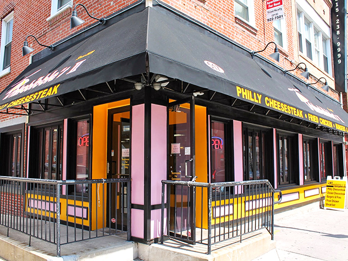 The unmistakable black awning with bold yellow lettering announces your arrival at cheesesteak paradise. South Street's pink and yellow beacon beckons hungry pilgrims.