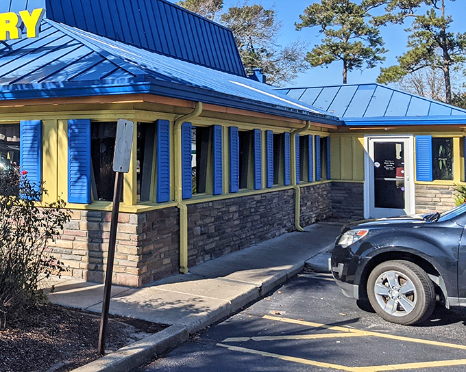 The sunshine-yellow exterior with that unmistakable blue roof isn't just a building&mdash;it's a morning beacon of breakfast possibilities waiting to happen.