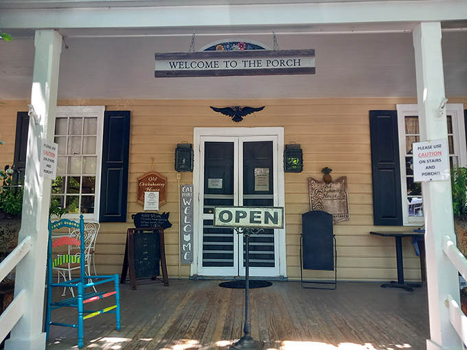 The porch says "Welcome" and means it. That bright blue rocking chair isn't just furniture&mdash;it's an invitation to slow down and savor what's coming. 