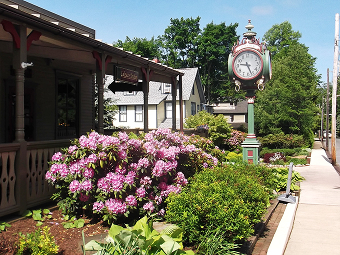 Downtown Eagles Mere showcases its timeless charm with a vintage clock standing sentinel among blooming rhododendrons – small-town Americana at its picture-perfect best.