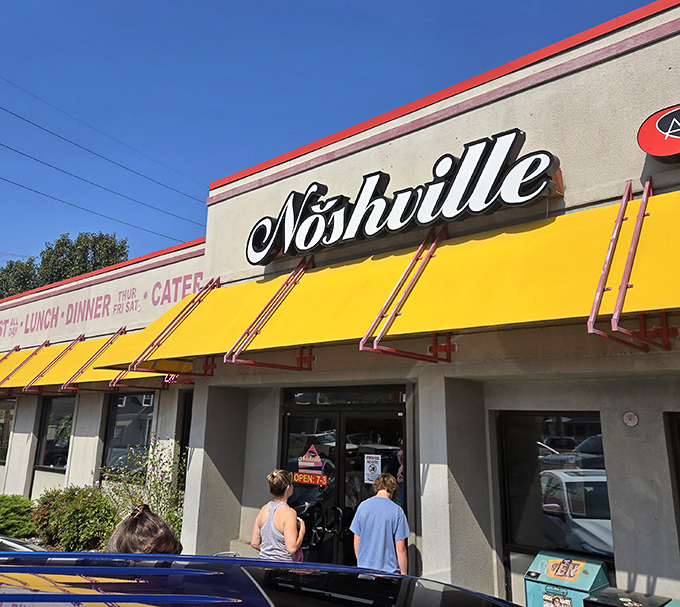 That bright yellow awning beckons like a beacon of comfort food hope in Nashville's bustling landscape.
