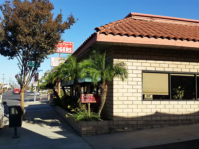 The Spanish-tiled roof and stone facade of Old Time Drive In stands like a culinary lighthouse, beckoning hungry travelers with promises of burger perfection.