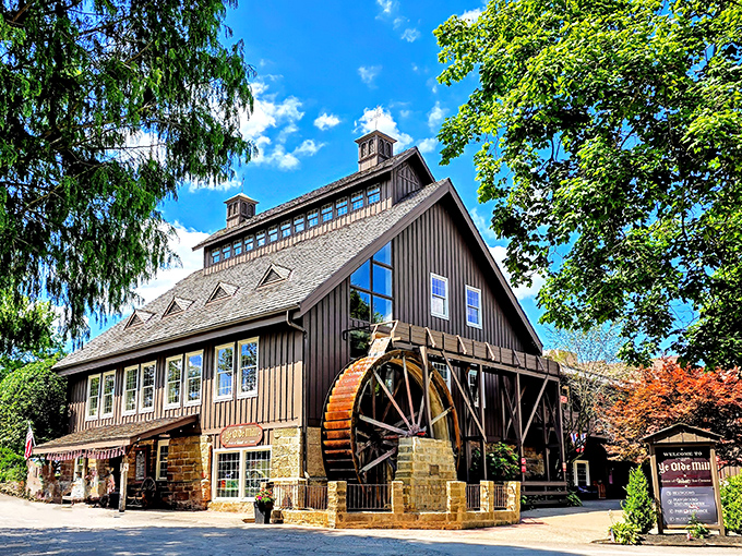 The historic Ye Olde Mill stands proudly against an Ohio blue sky, its wooden water wheel promising sweet memories and even sweeter treats inside.