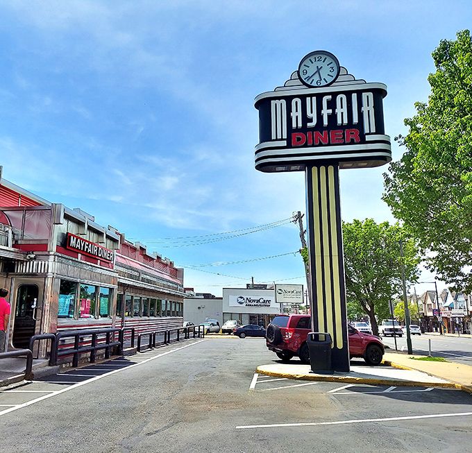 The iconic Mayfair Diner sign stands tall against the Philadelphia sky, a beacon of comfort food that's been calling hungry patrons home for generations.