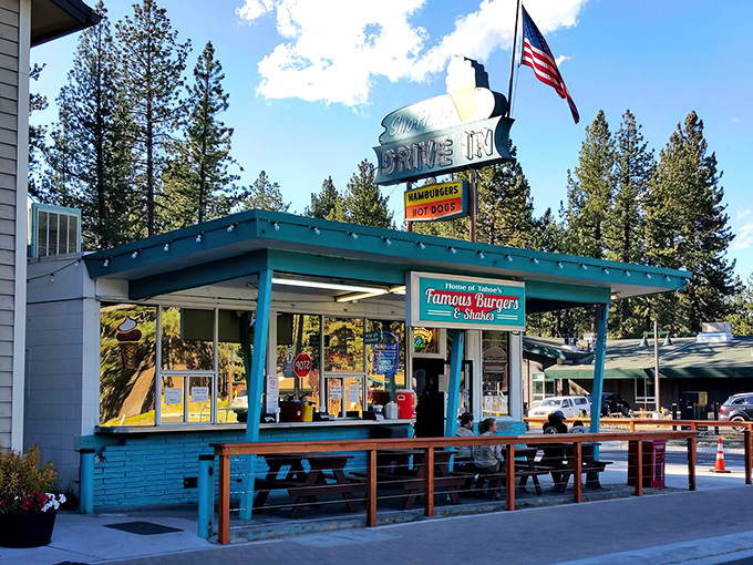 The iconic turquoise-blue Sno-Flake Drive-In stands proudly against Tahoe's pine backdrop, its vintage sign promising burgers and nostalgia in equal measure.