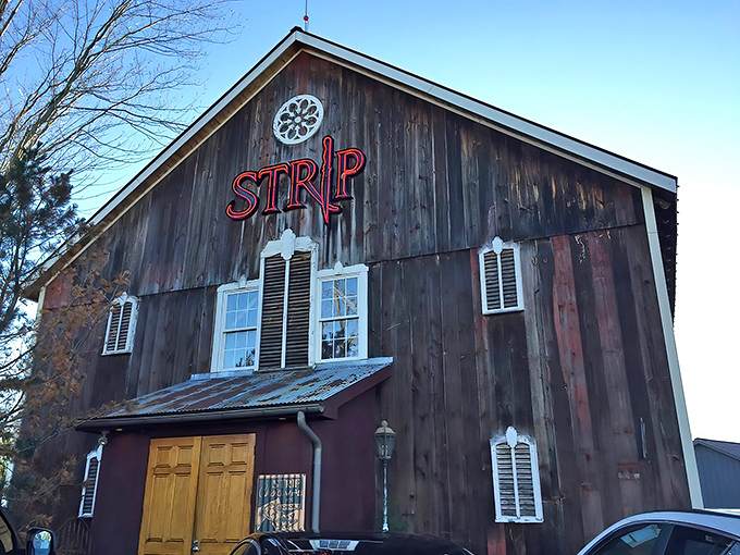 The rustic barn exterior of Strip Steakhouse stands as a delicious contradiction&mdash;fine dining hiding in plain sight among Avon's countryside charm.