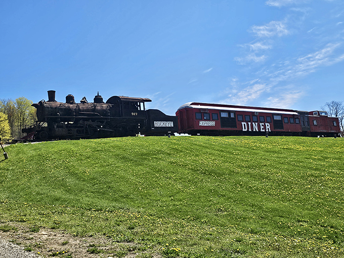 The majestic 917 locomotive stands sentinel outside the Buckeye Express, its weathered steel telling tales of journeys past while promising delicious adventures ahead.