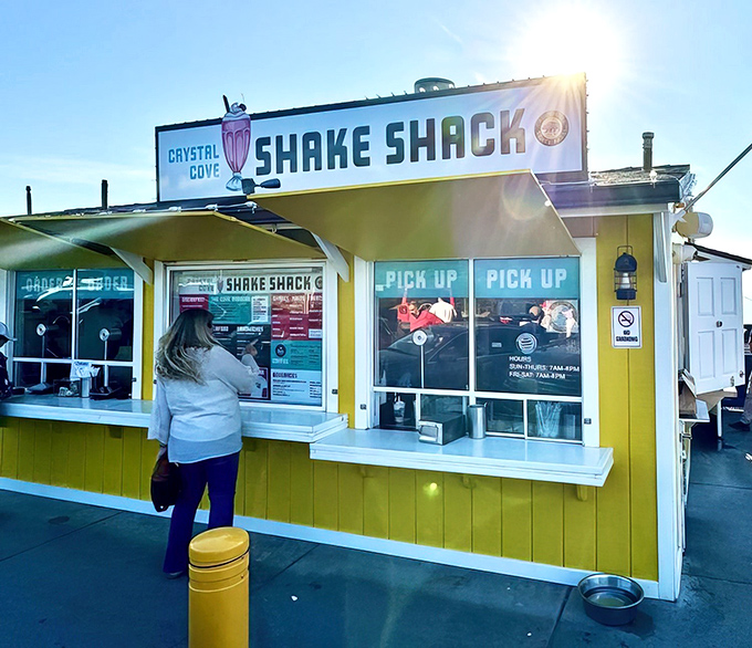 That cheerful yellow beacon on the cliff isn't just a building—it's a promise of burgers with a side of Pacific paradise.