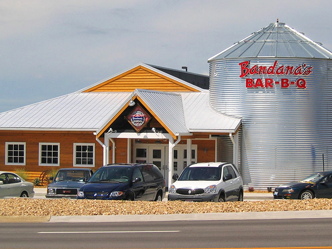The iconic grain silo with "Bandana's BAR-B-Q" in bold red letters stands like a barbecue lighthouse, beckoning hungry travelers to this rustic wooden haven.