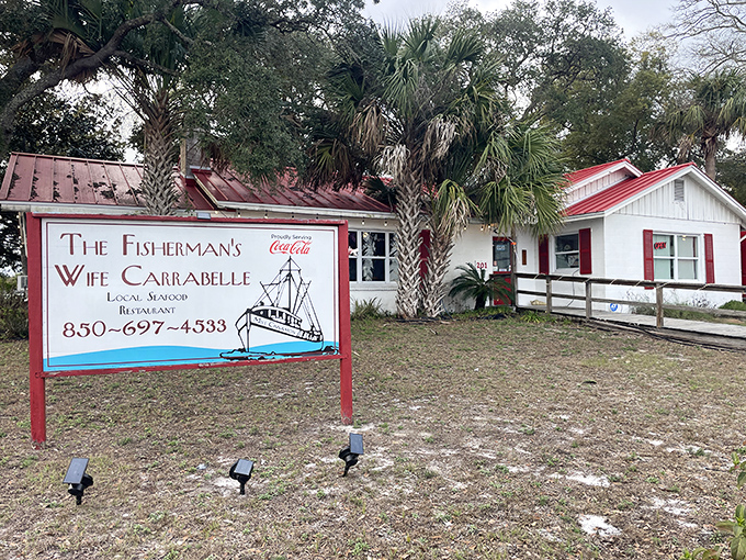 The unassuming white cottage with its weathered red roof and hand-painted sign promises what Florida seafood should be: fresh, unpretentious, and absolutely worth finding.