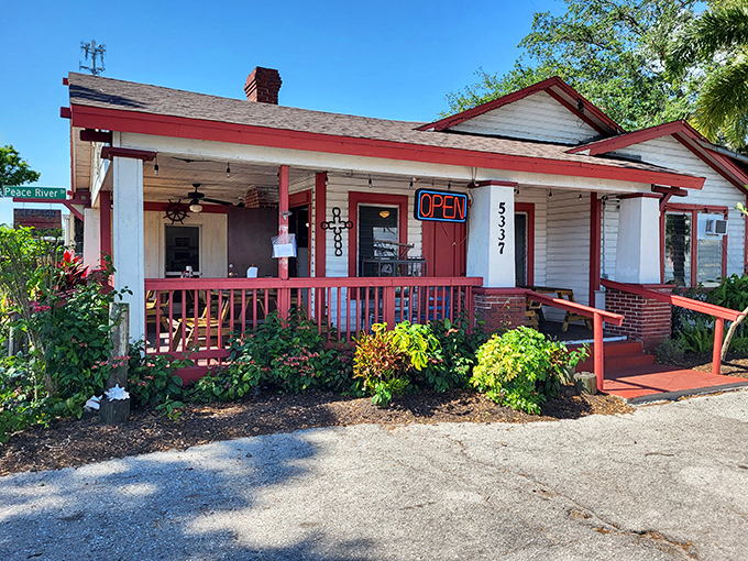 Old Florida charm doesn't get more authentic than this red-trimmed cracker house. The neon "OPEN" sign might as well say "Seafood Paradise Found."