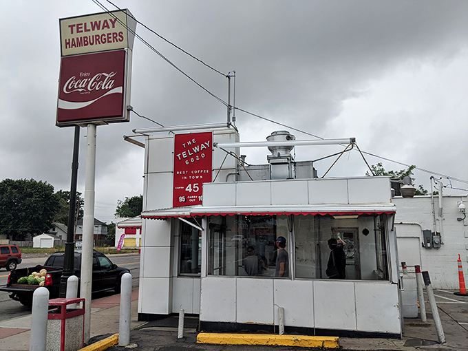 The iconic white cube of Telway stands like a time capsule on Detroit's landscape, its vintage sign beckoning burger lovers for generations.