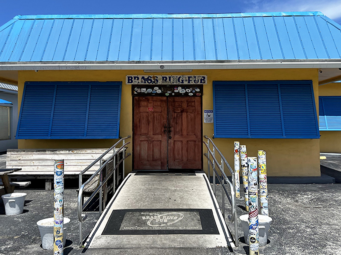 The unassuming blue-roofed exterior of Brass Ring Pub stands like a culinary lighthouse, beckoning burger pilgrims with the promise of greatness within.