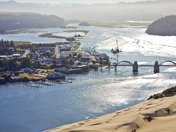 The Siuslaw River meets the Pacific in a shimmering embrace, with Florence nestled perfectly between mountains, forest, and sea. Nature's perfect sandwich.