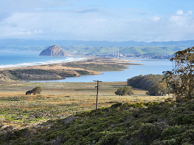 Morro Rock stands like nature's own monument, commanding attention across the tranquil bay waters. Sailboats drift peacefully, completing this quintessential Central Coast postcard.