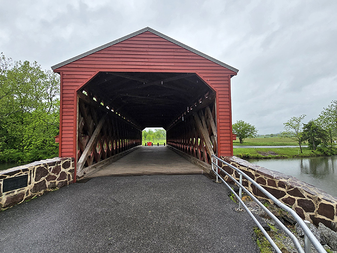 The iconic red exterior of Sachs Bridge welcomes visitors with its Town truss design. History and haunting tales await inside this 170-year-old Gettysburg landmark.