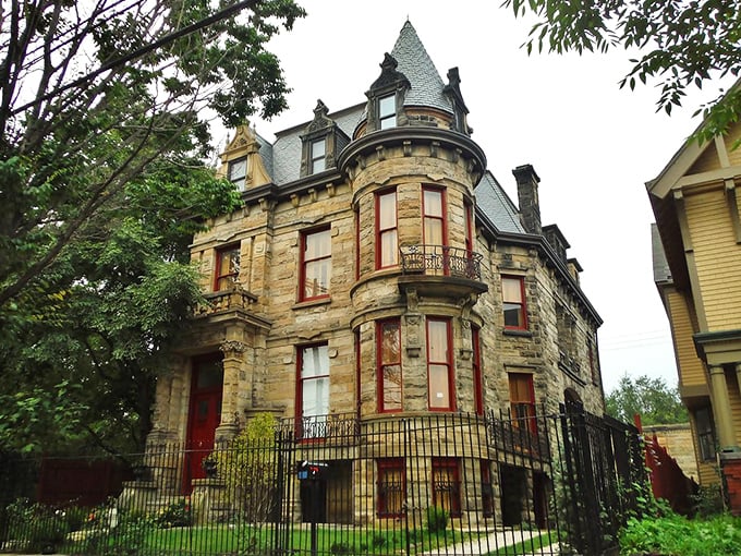 The stone facade of Franklin Castle stands defiantly against time, its turrets and bay windows practically daring you to knock on that crimson door.