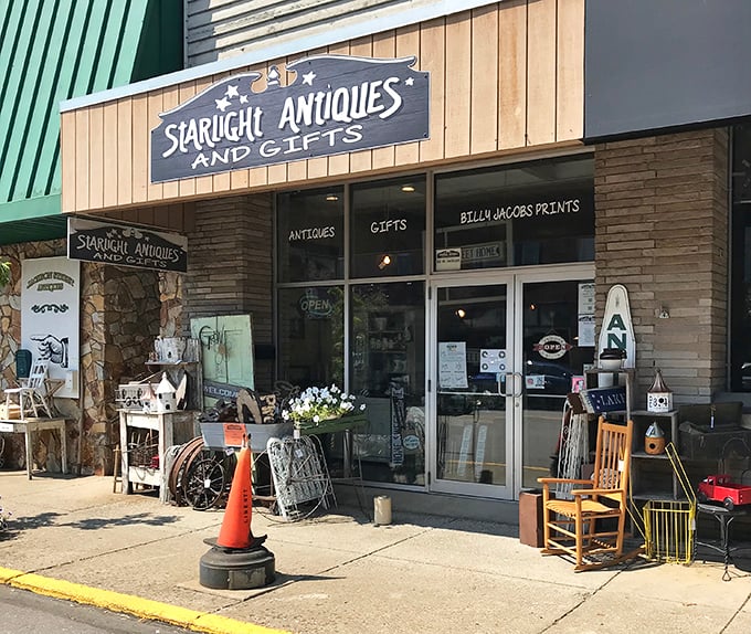 The storefront beckons like an old friend with treasures spilling onto the sidewalk. That orange traffic cone? Probably directing traffic to the bargains inside. 