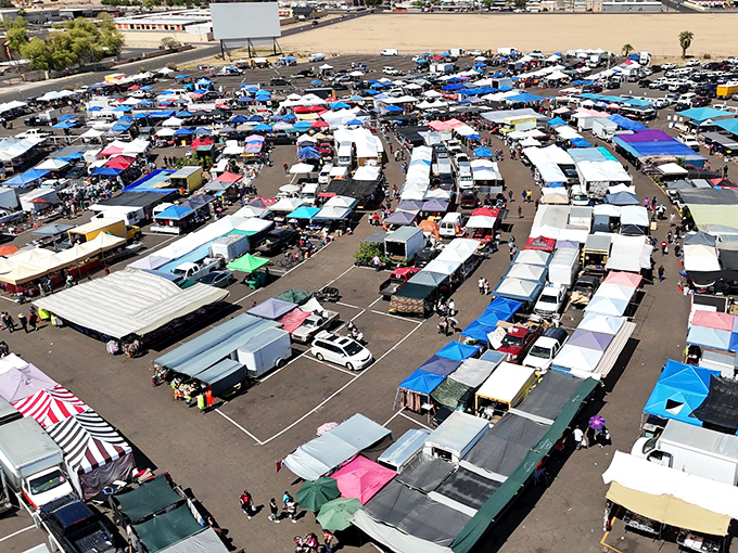 From above, it's a kaleidoscope of commerce—hundreds of canopies creating a temporary city where treasure hunters navigate the maze of possibilities.