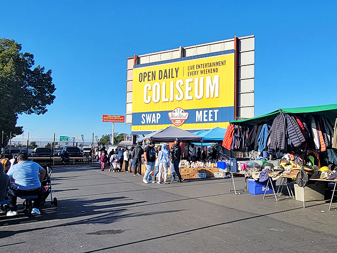 The iconic yellow and blue Coliseum Swap Meet sign stands like a beacon of bargain-hunting possibilities, promising treasures waiting to be discovered.