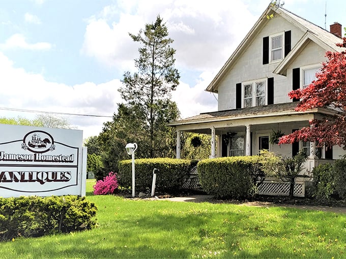 The classic white farmhouse exterior of Jameson Homestead Antiques stands like a time capsule waiting to be opened, complete with inviting porch and vintage charm.