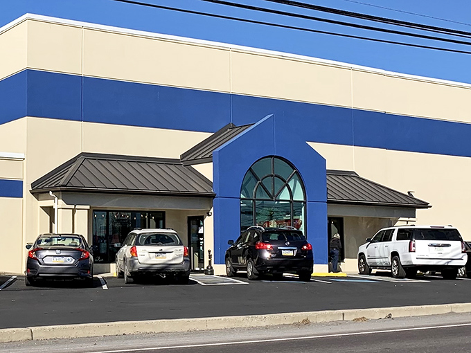 The blue-striped facade of Re-Uzit Shop stands like a retail oasis in New Holland, promising treasures within its unassuming exterior.