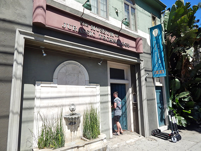 The unassuming facade of wonder &ndash; where curiosity lives behind a mint-green exterior and burgundy sign that promises the unexpected.