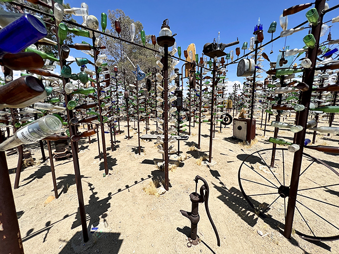 Where Route 66 meets artistic genius! This railroad crossing sign stands sentinel among a forest of glittering glass, like a traffic cop directing dreams.