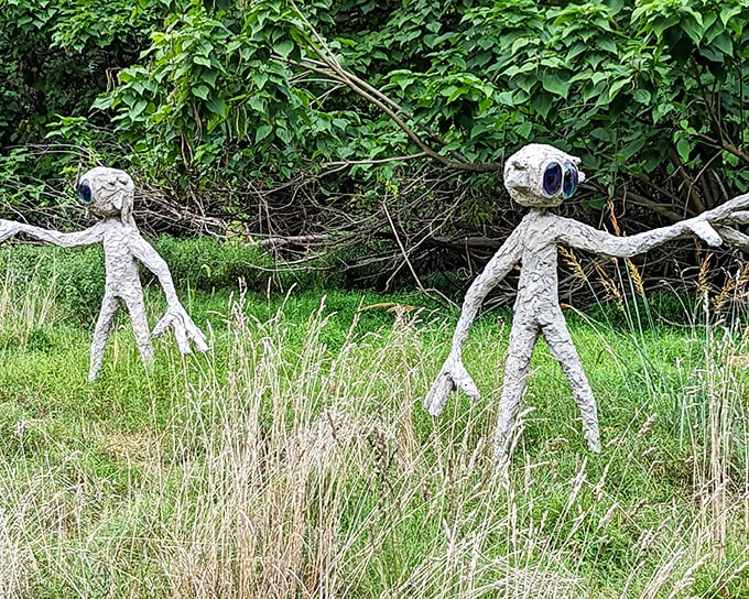 The magnificent Folk Arch stands like a portal to another dimension, its stone and concrete surface adorned with faces, symbols, and found objects that tell mysterious stories.