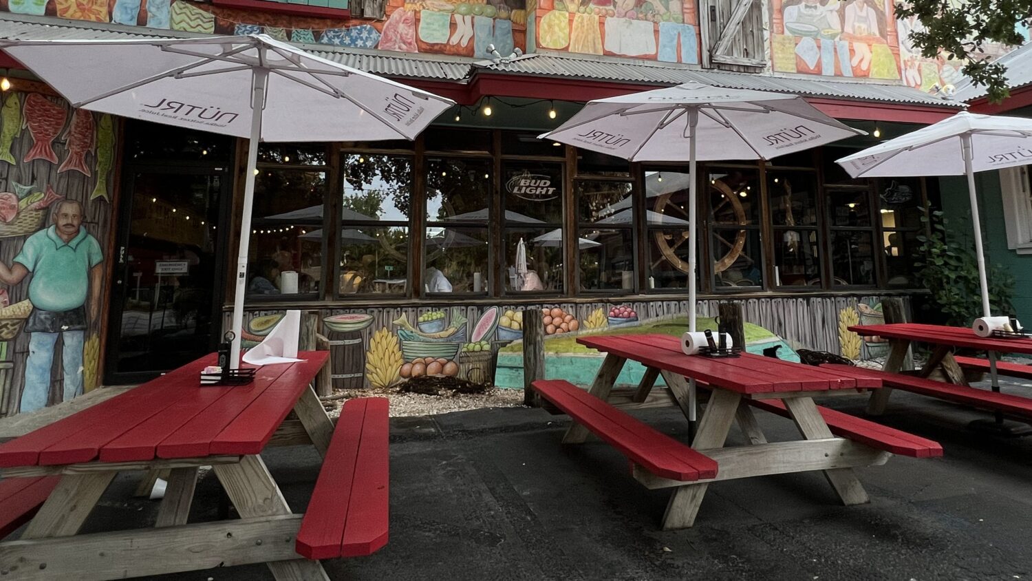 The colorful exterior of Fourth Street Shrimp Store welcomes you with vibrant murals and cherry-red picnic tables. Florida dining at its most authentically unpretentious.