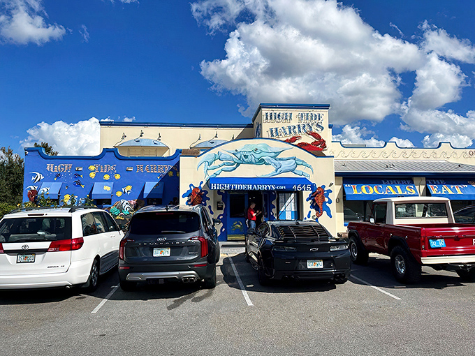 The blue and white facade of High Tide Harry's stands like a beacon for seafood lovers, promising treasures from the deep with its playful crab signage.