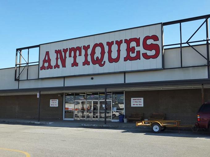 The red block letters spelling "ANTIQUES" aren't just a sign&mdash;they're a promise of treasure hunting adventures waiting just beyond those doors.